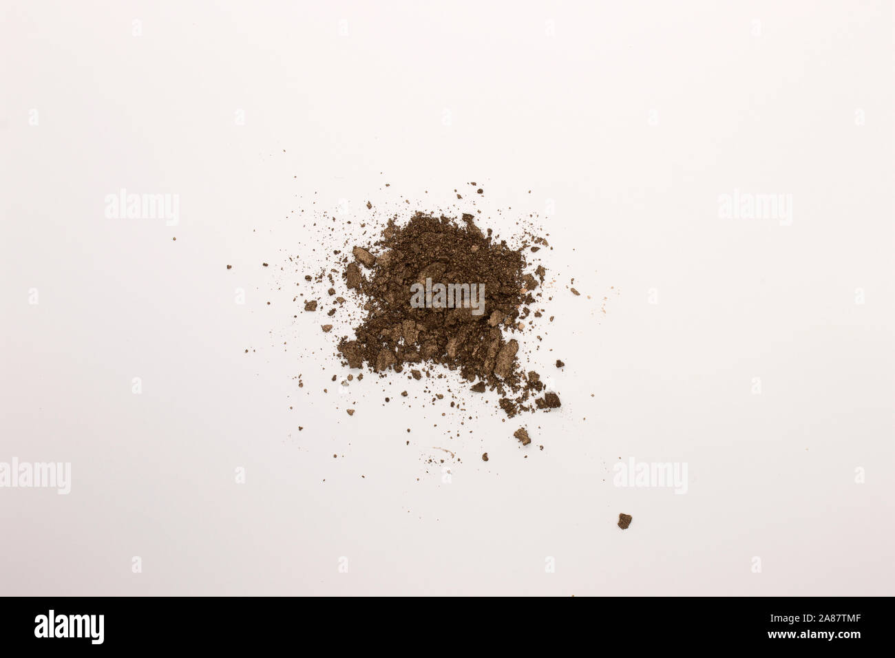 This is a photograph of a Dark Brown powder Eye shadow isolated on a ...