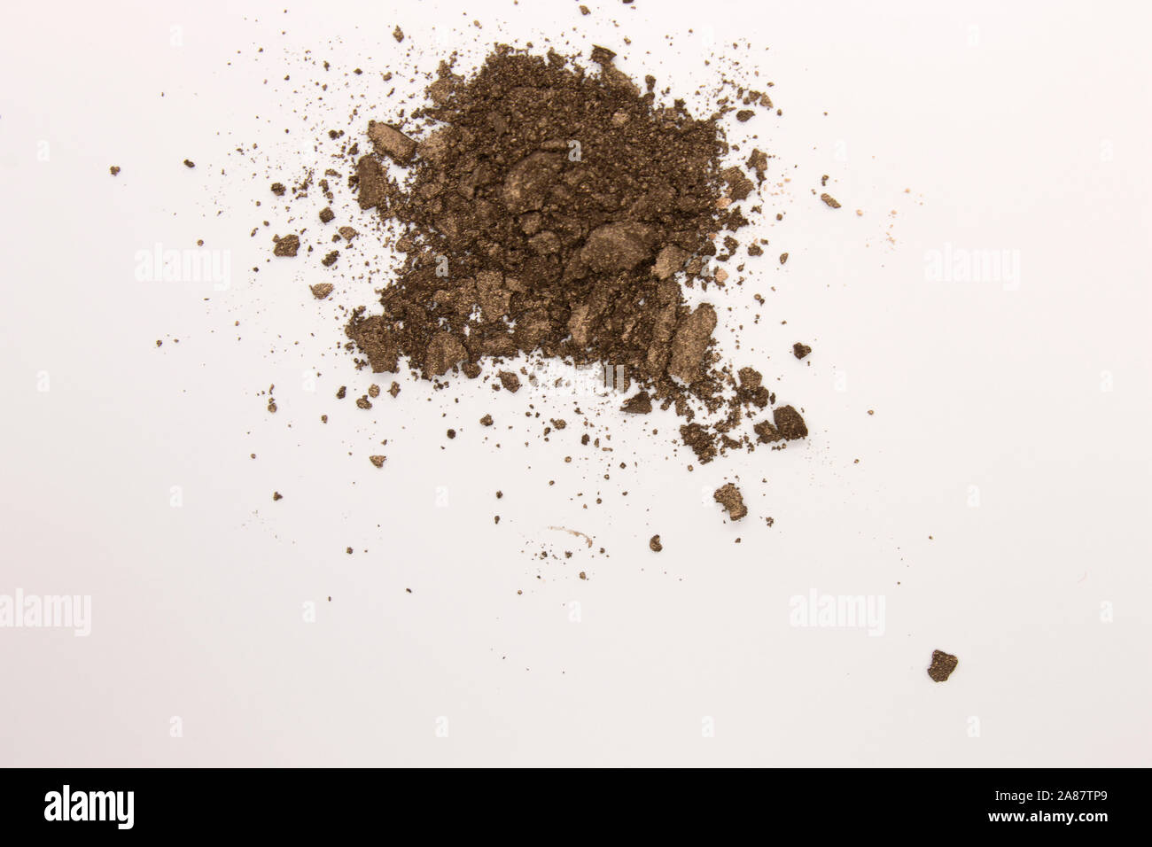 This is a photograph of a Dark Brown powder Eye shadow isolated on a ...