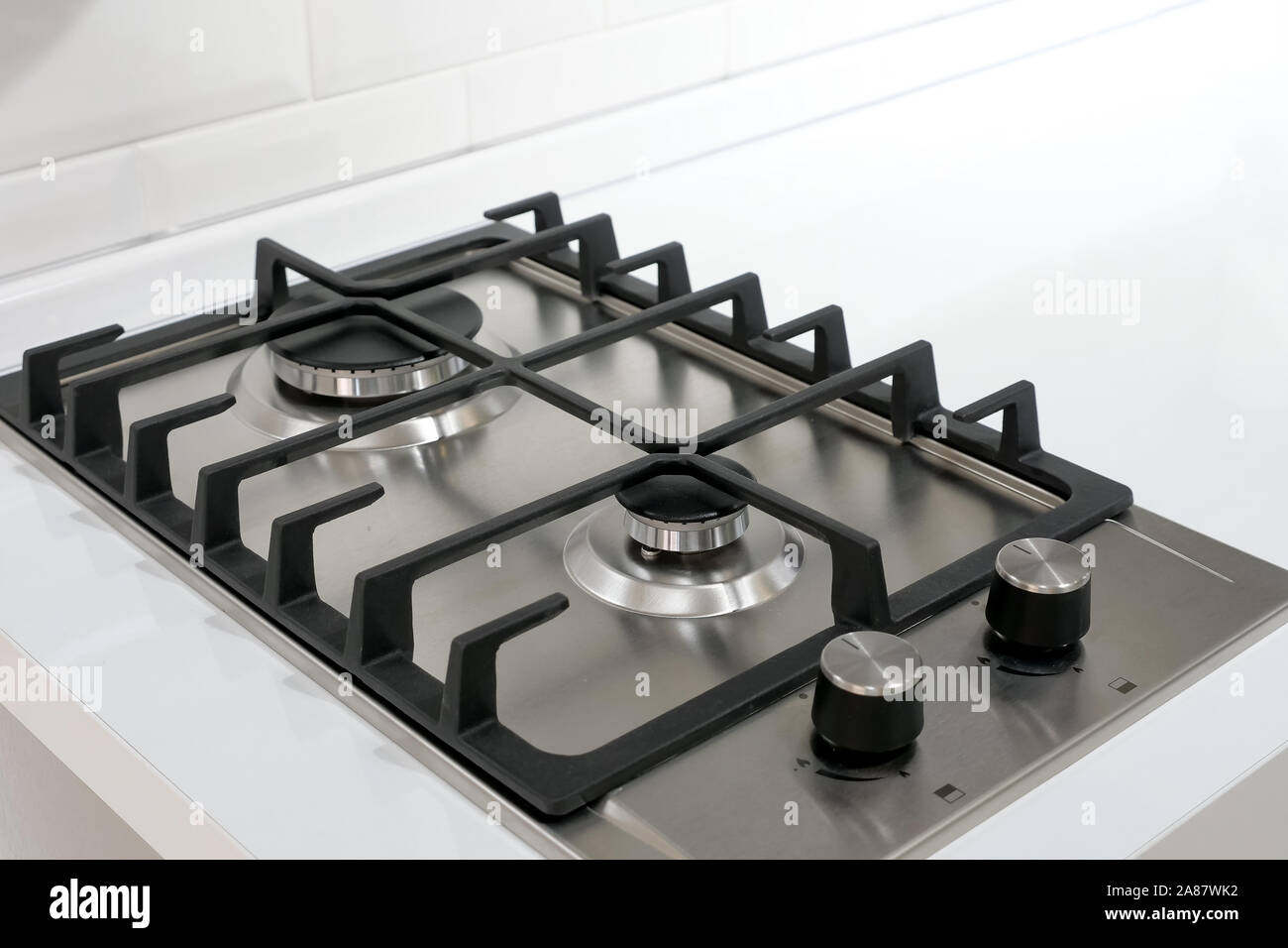 modern stainless steel silver gas stove with black elements and burners ...