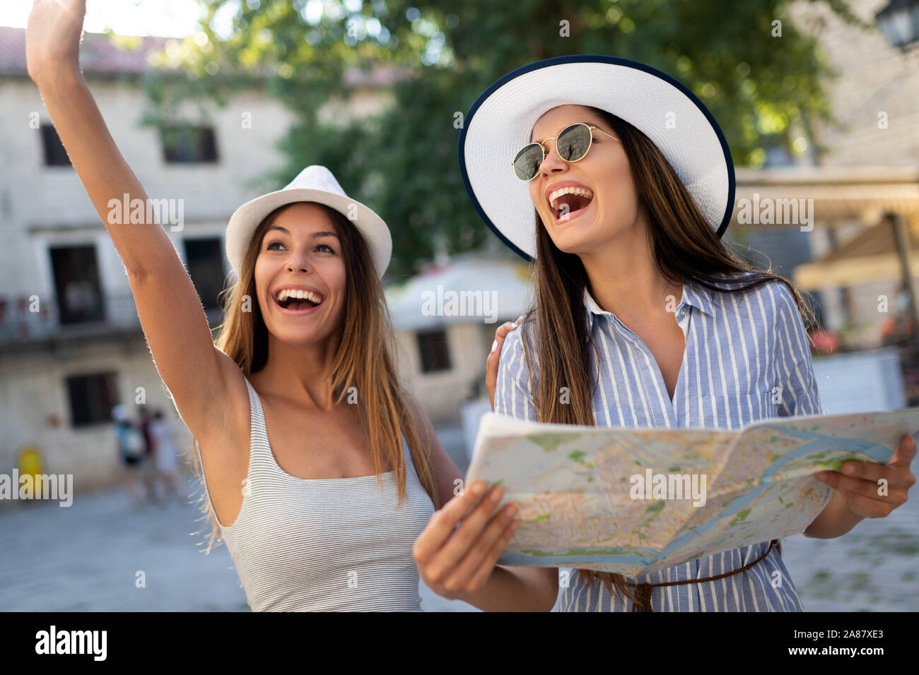Young happy tourists women sightseeing in city on vacation Stock Photo ...