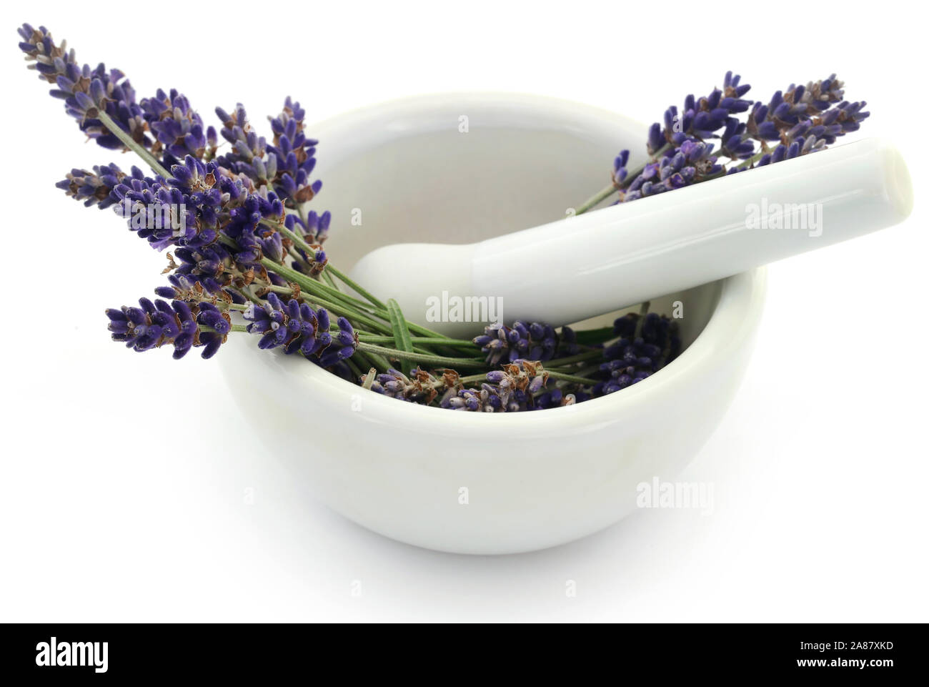 Lavender flower in a mortar with pestle over white background Stock Photo - Alamy