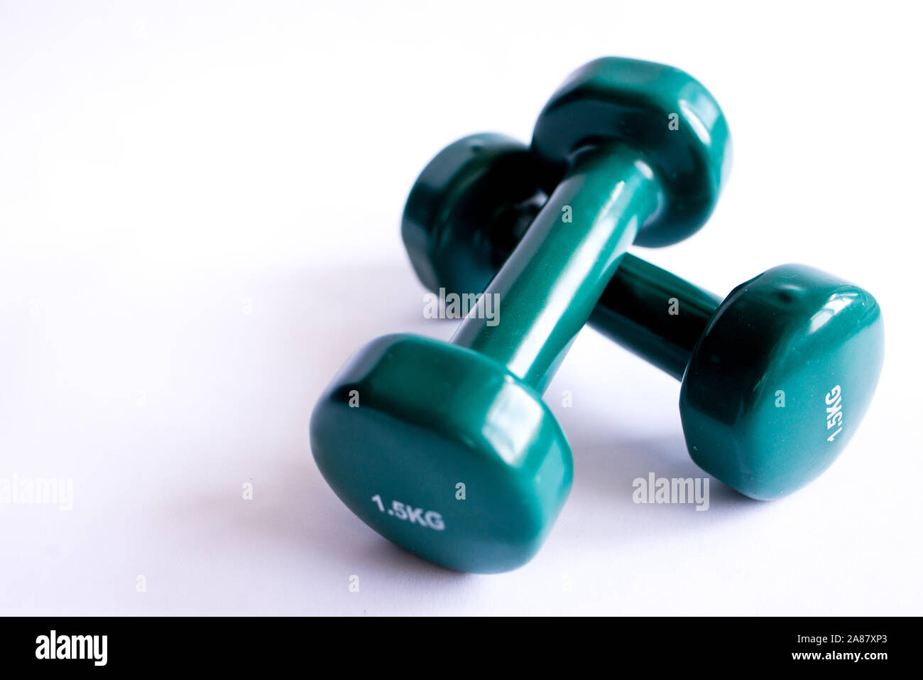 dumbbells and measuring tape on white Stock Photo - Alamy