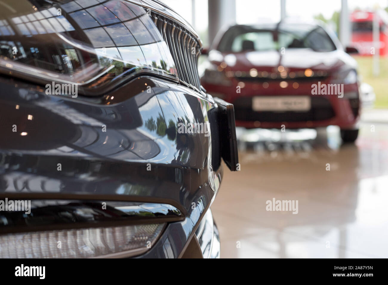 New cars at dealer showroom. Themed blur background with bokeh effect ...