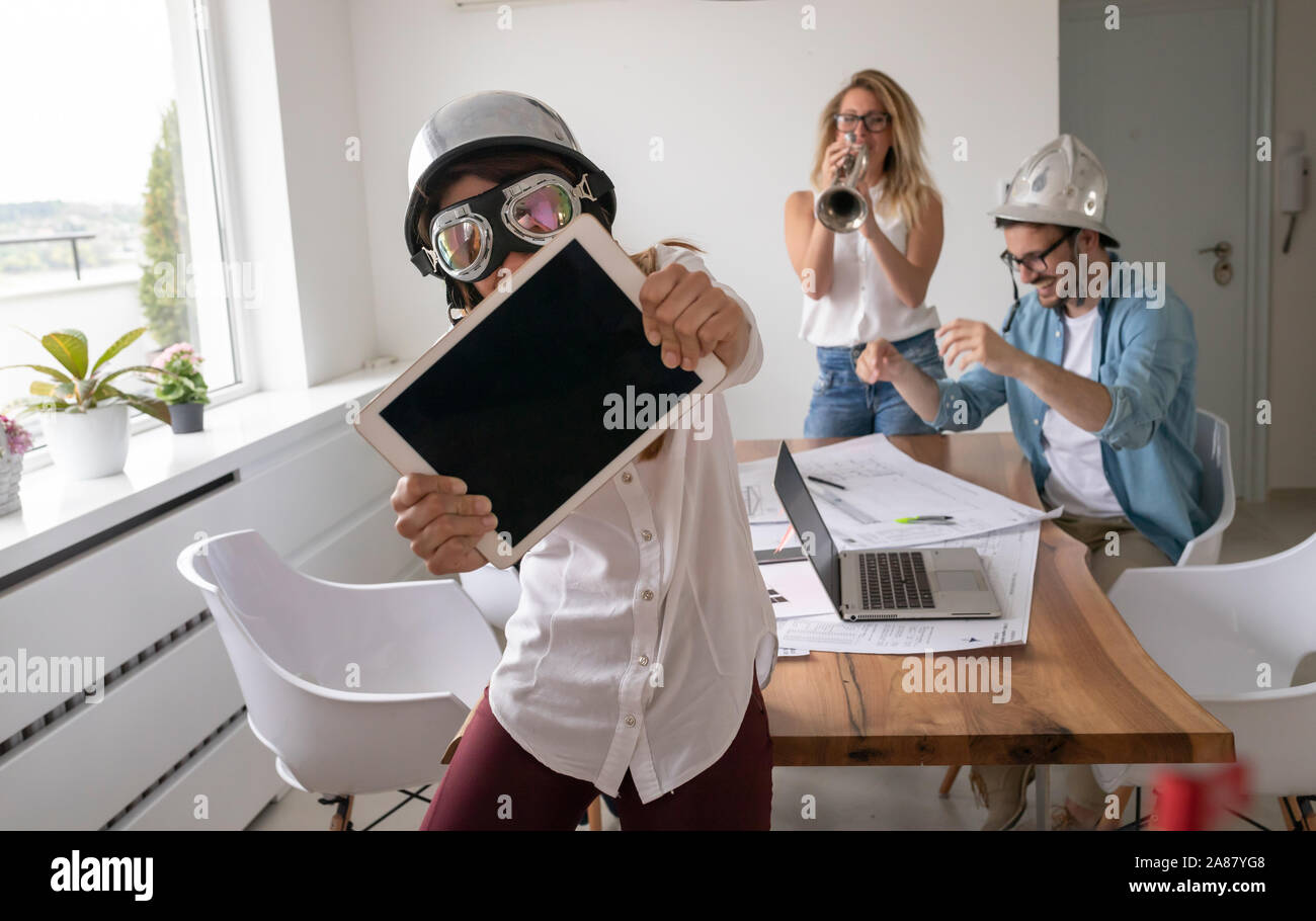 Fun in the office. Cheerful business people in smart casual wear having ...