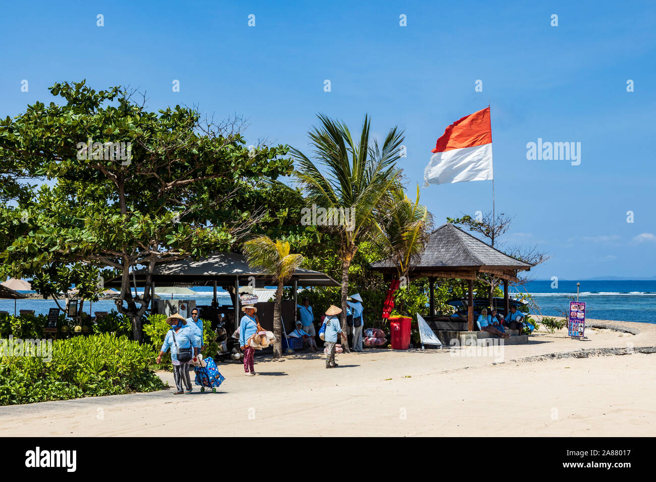 Beach with local women and Indonesian flag at Nusa Dua, Bali, Indonesia ...