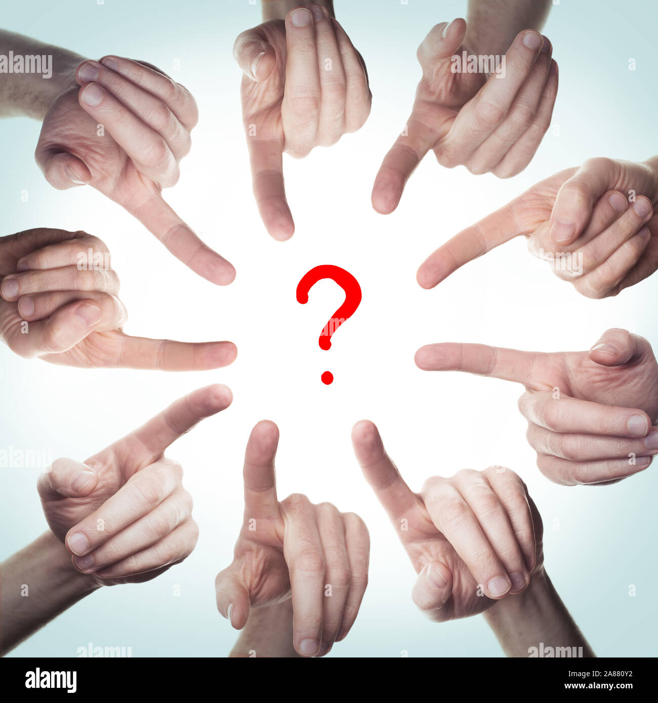 Many hands point to a question mark. Concept the solution of the ...
