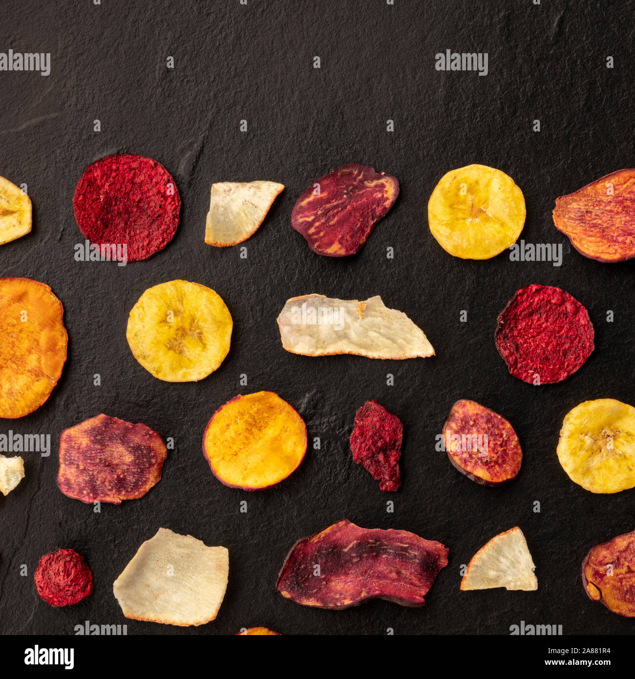 Dried fruit and vegetable chips, square overhead shot with a place for ...