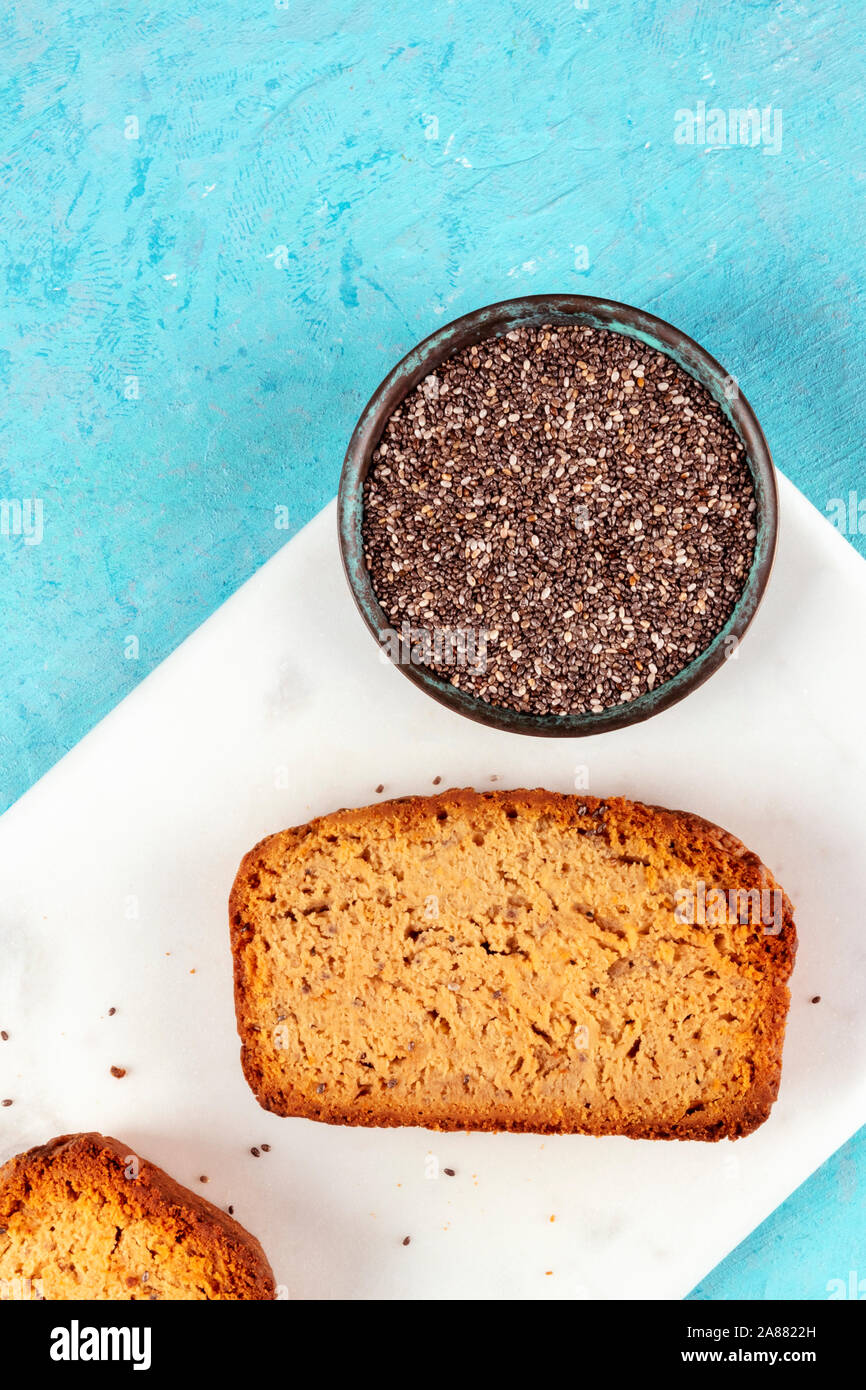 Chia seed cake, overhead shot on a marble cutting board and a blue ...