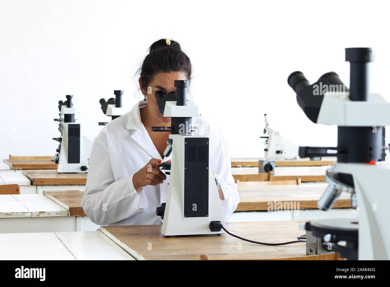 Researcher in the laboratory with microscope Stock Photo - Alamy