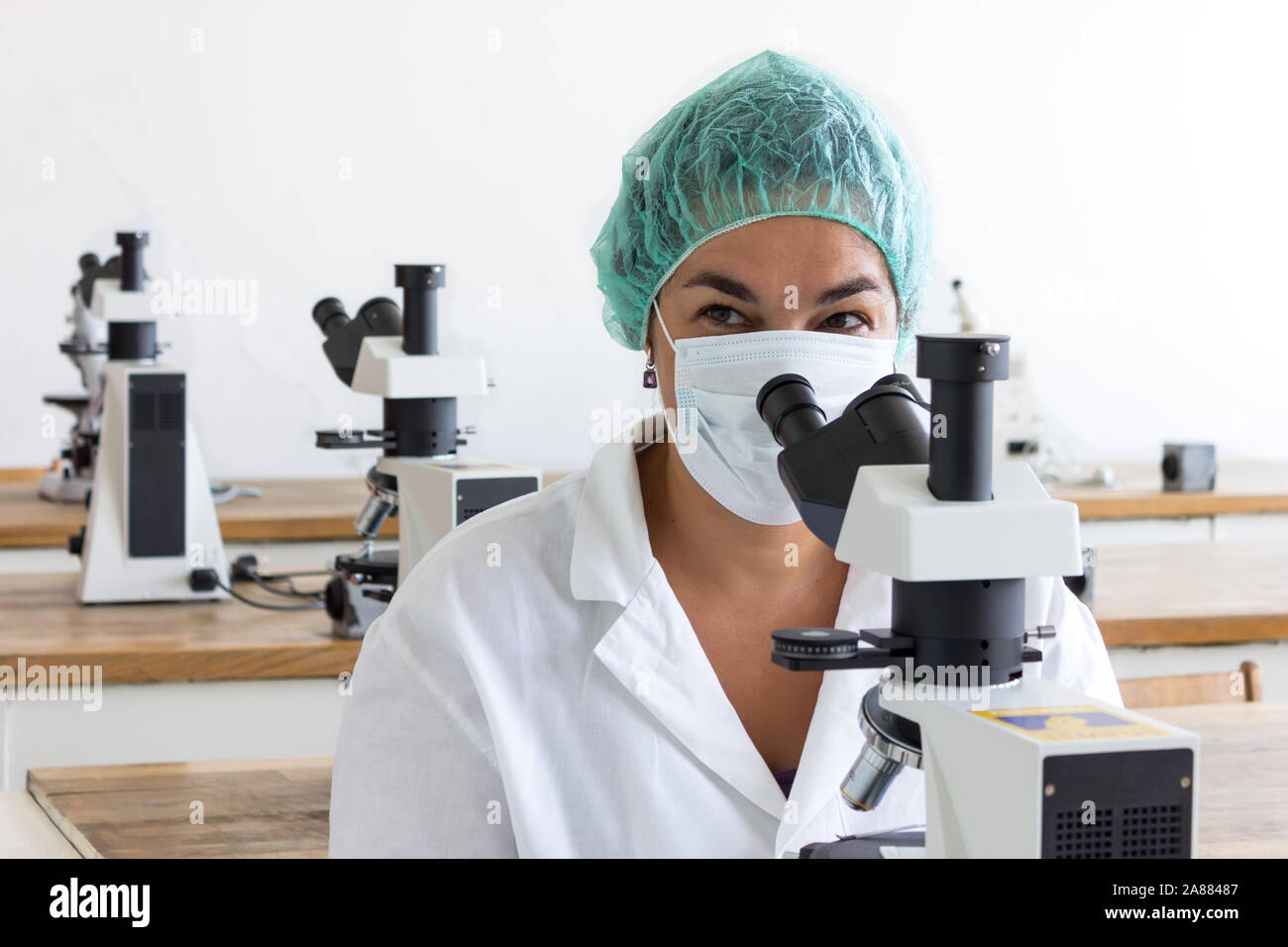 Researcher in the laboratory with microscope Stock Photo - Alamy