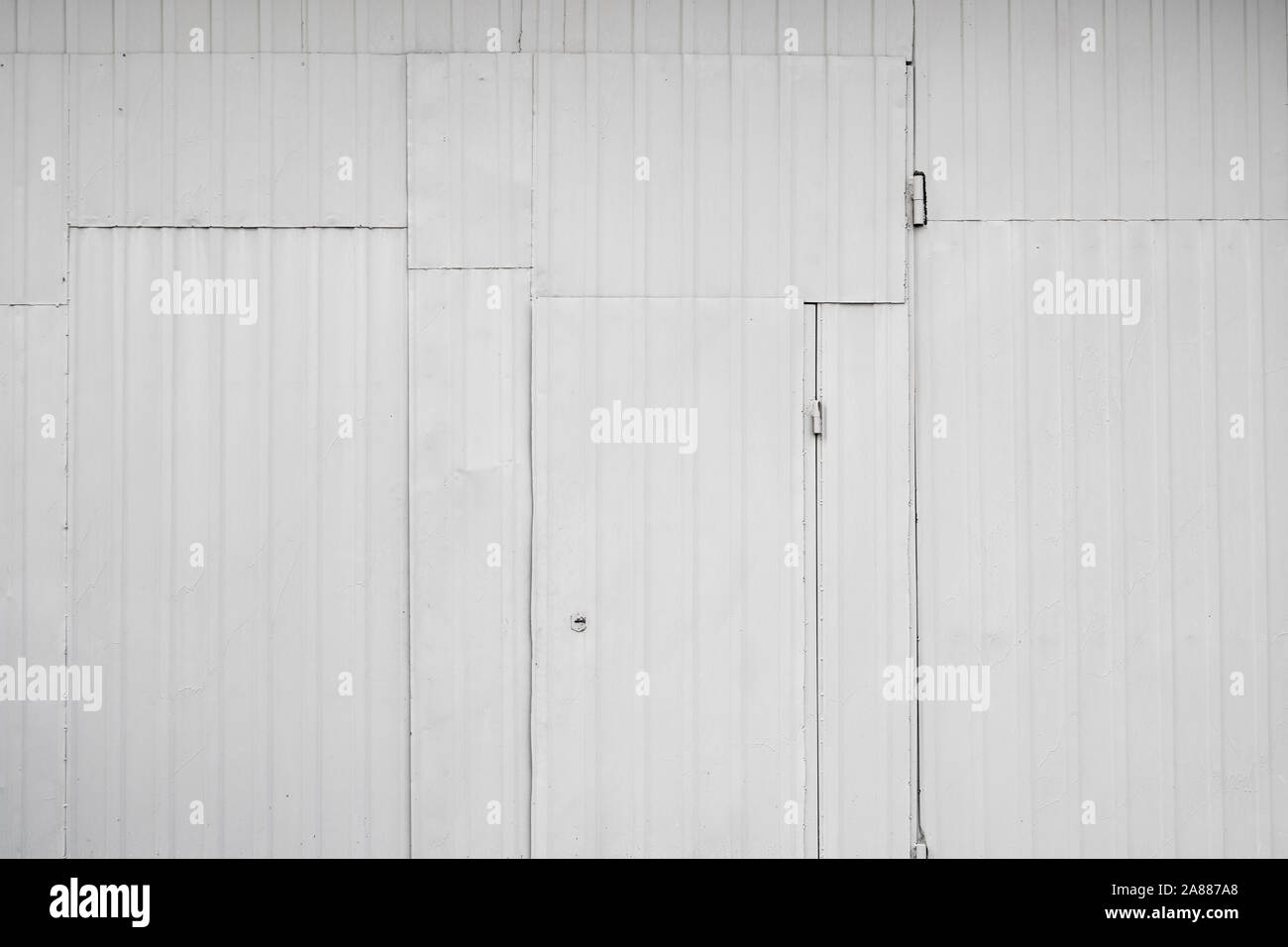 Old metal box with a door , white metal sheets with rivets, background ...
