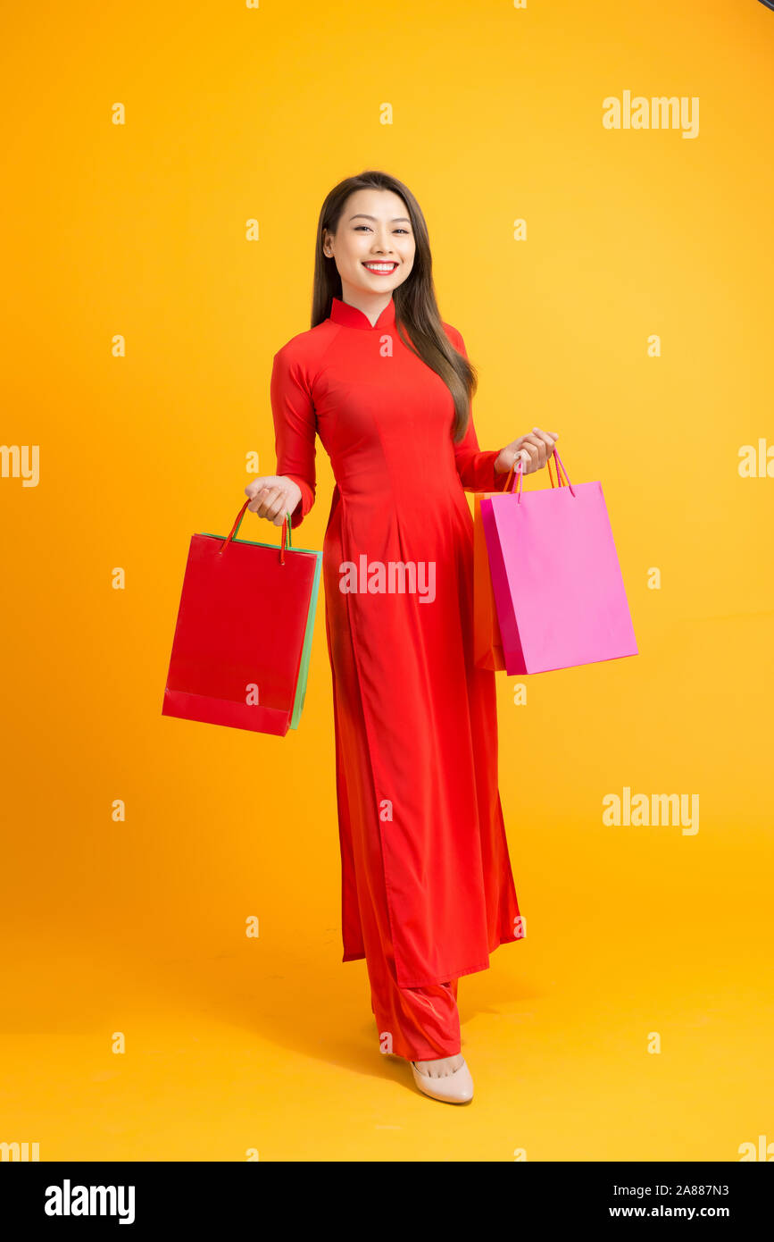 Vietnamese woman wearing traditional ao dai clothes and holding ...