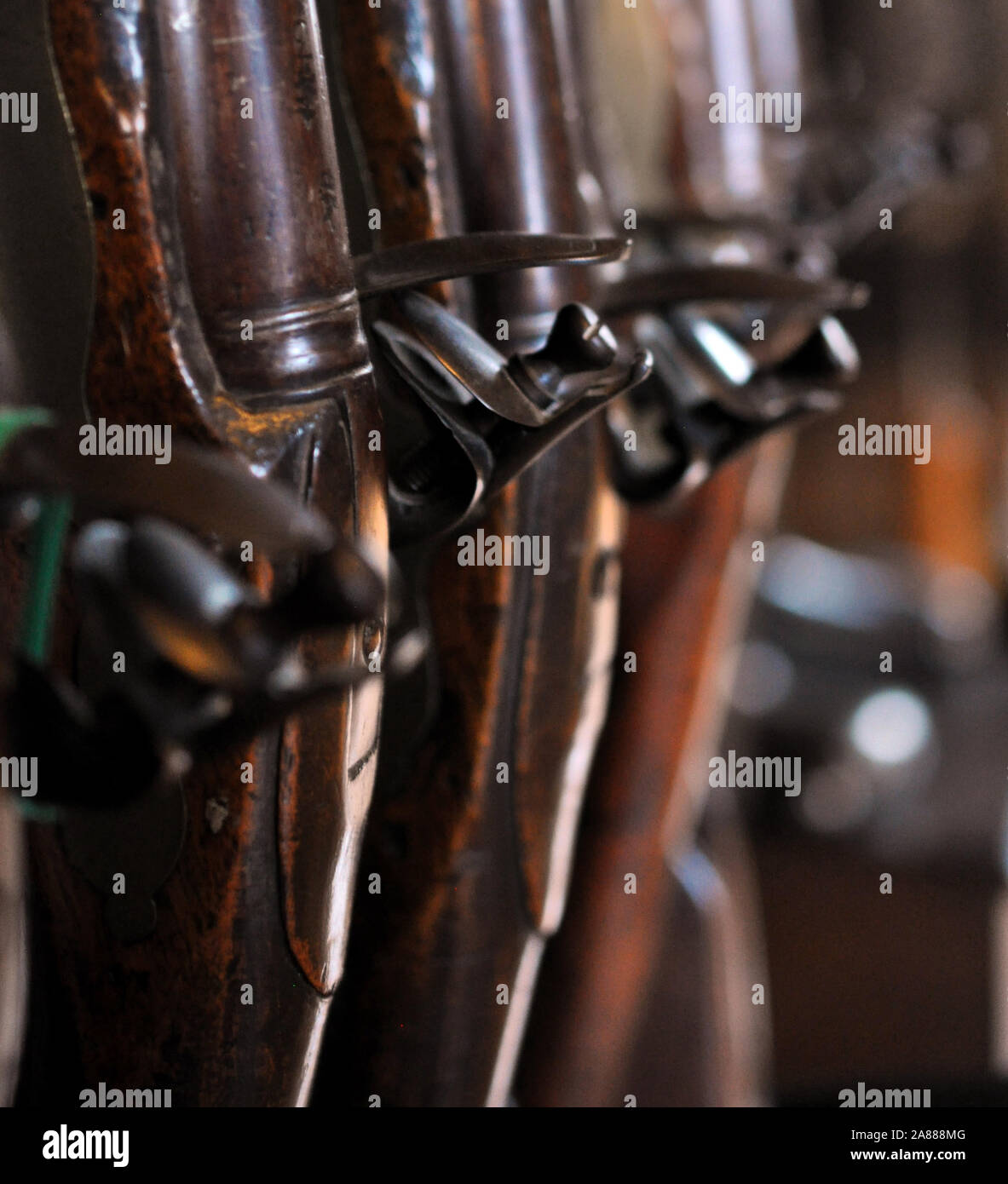 Three Flintlock guns, viewed as a perspective along the actual flint ...