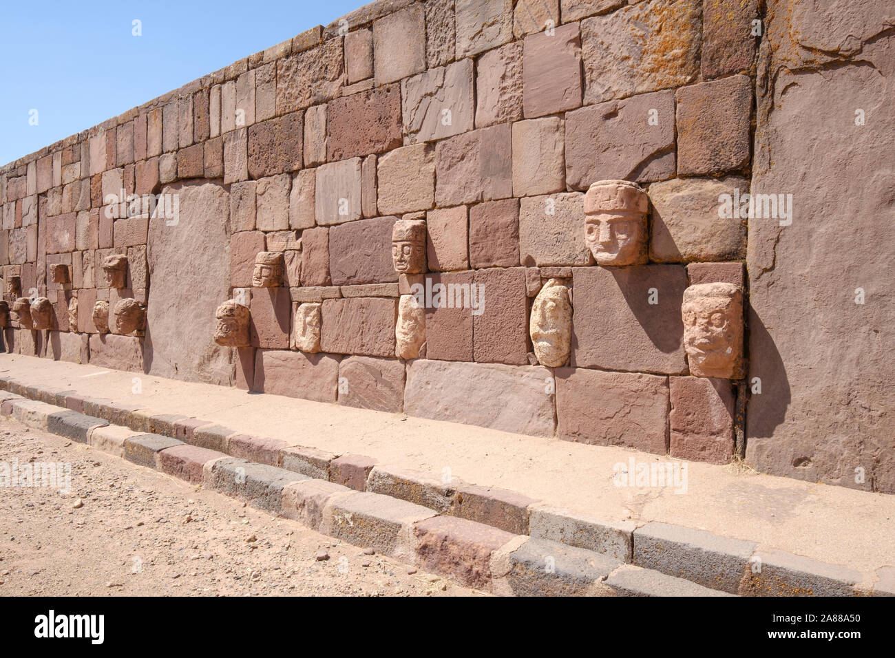 Carved stone tenon heads on the walls of the Semi-underground Temple in ...