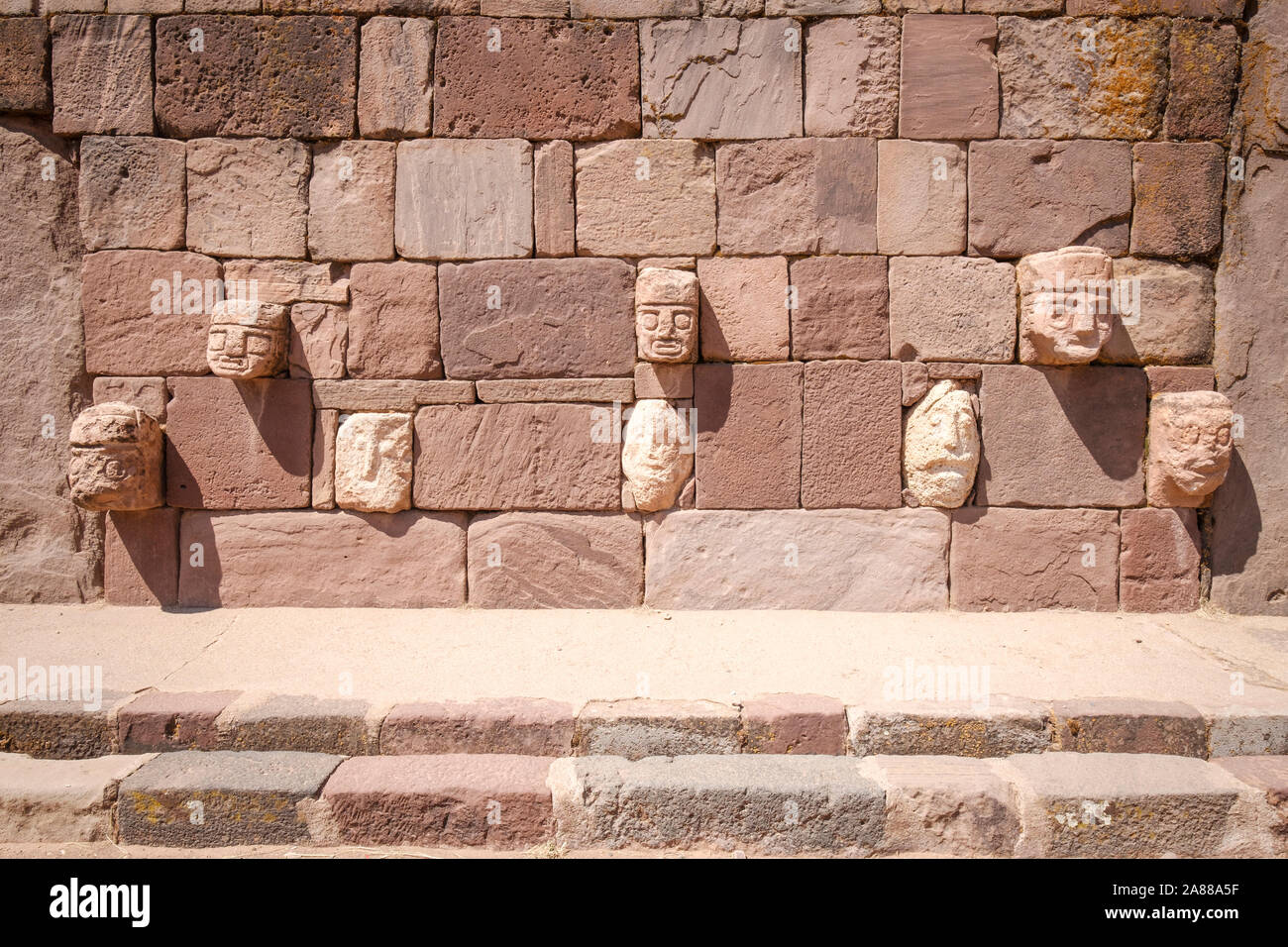 Carved stone tenon heads on the walls of the Semi-underground Temple in ...