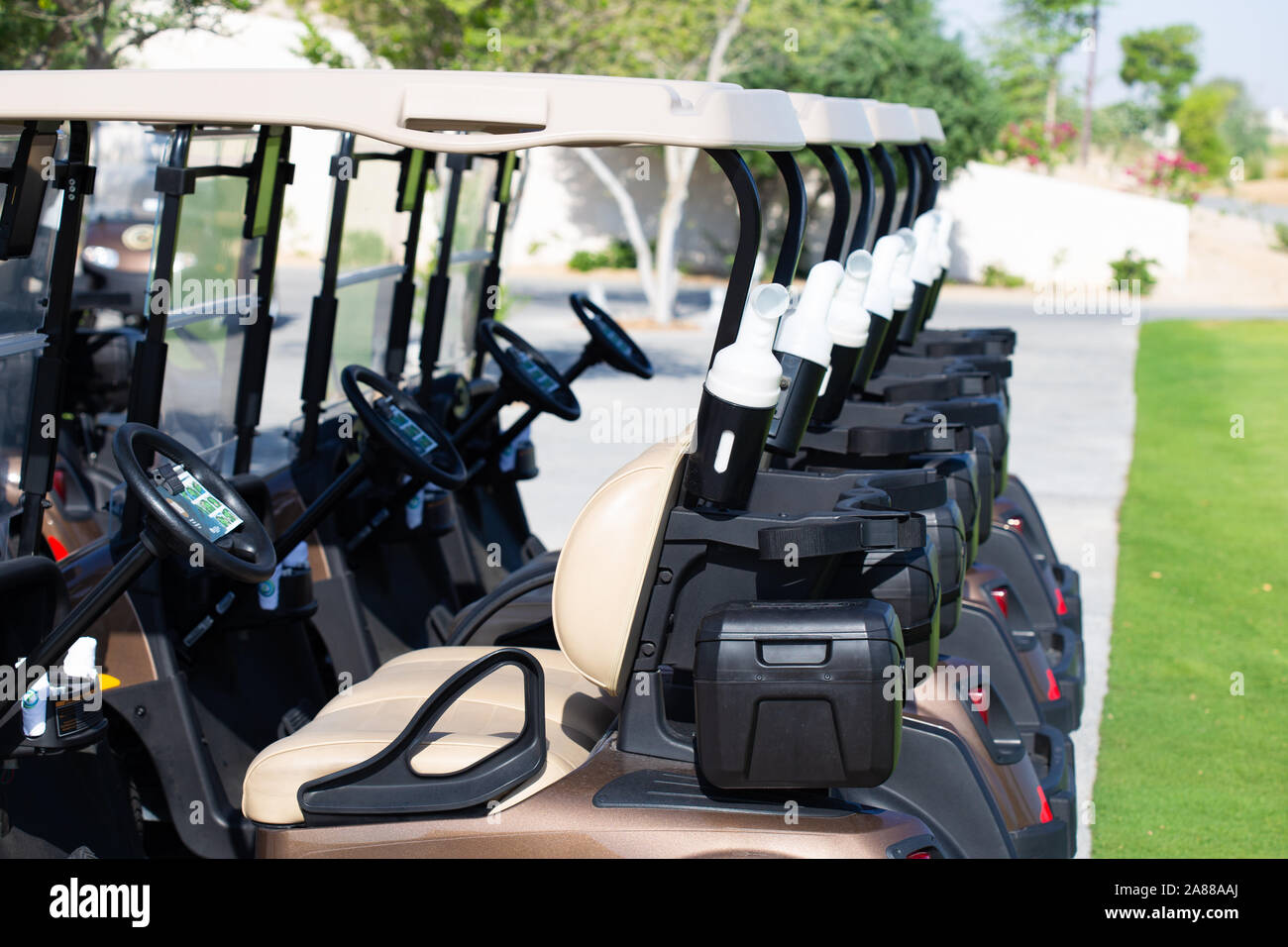 Golf cart on a golf closure.. Green field and cloudy blue sky. Spring ...