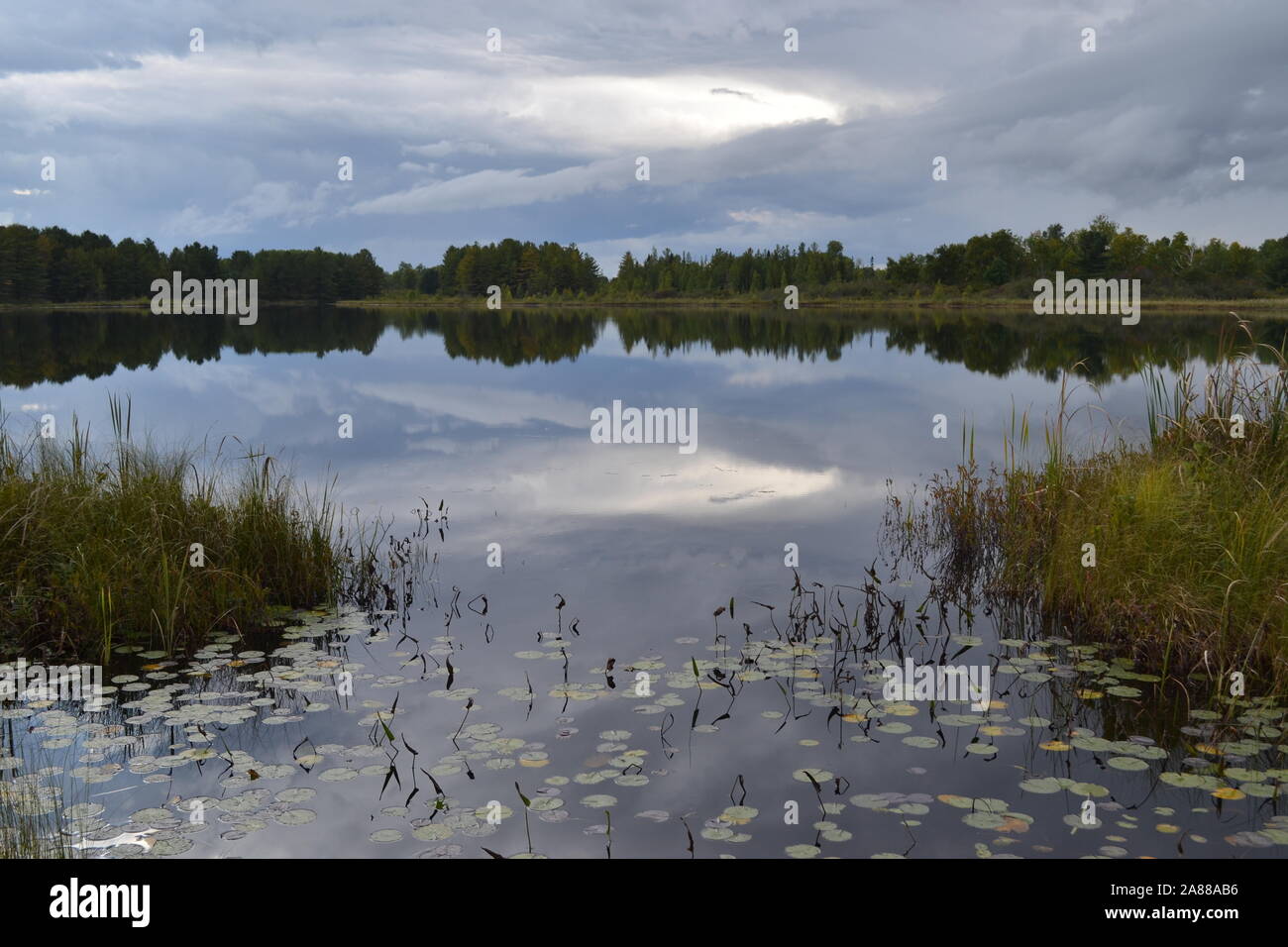 Calm water in fall and reflection Stock Photo - Alamy