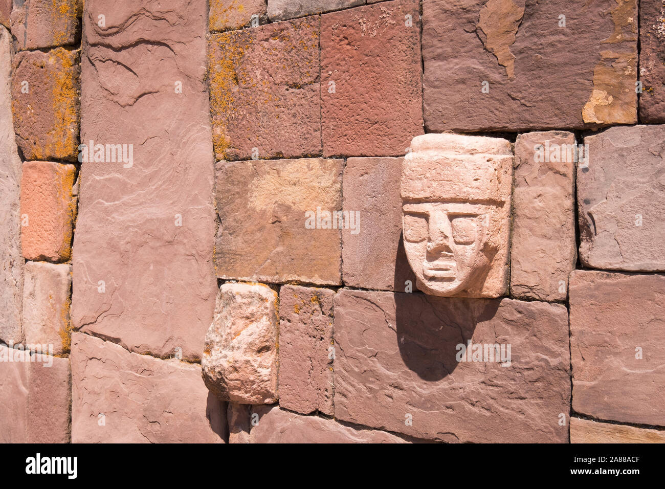 Carved stone tenon head on the walls of the Semi-underground Temple in ...