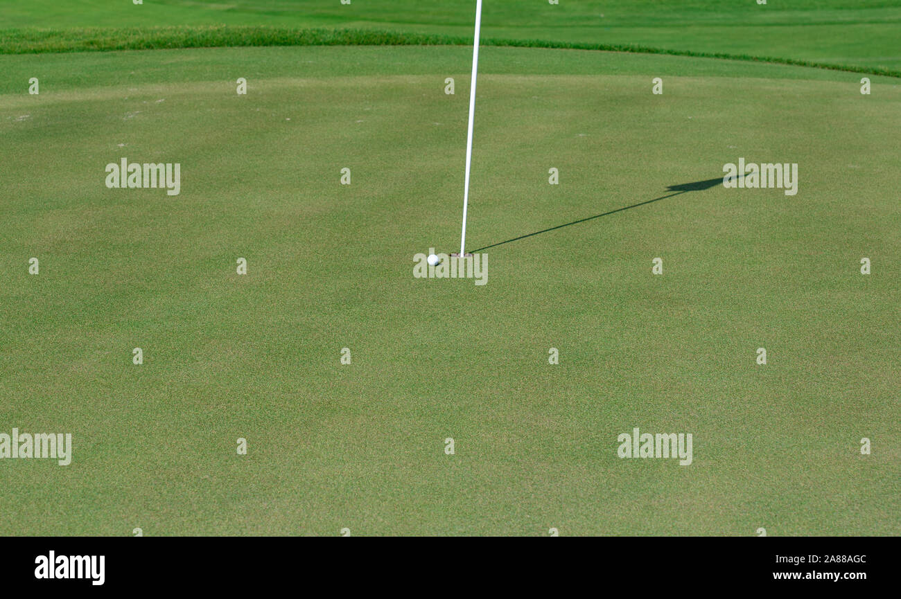 top view of iron golf club and ball on a green grass Stock Photo - Alamy