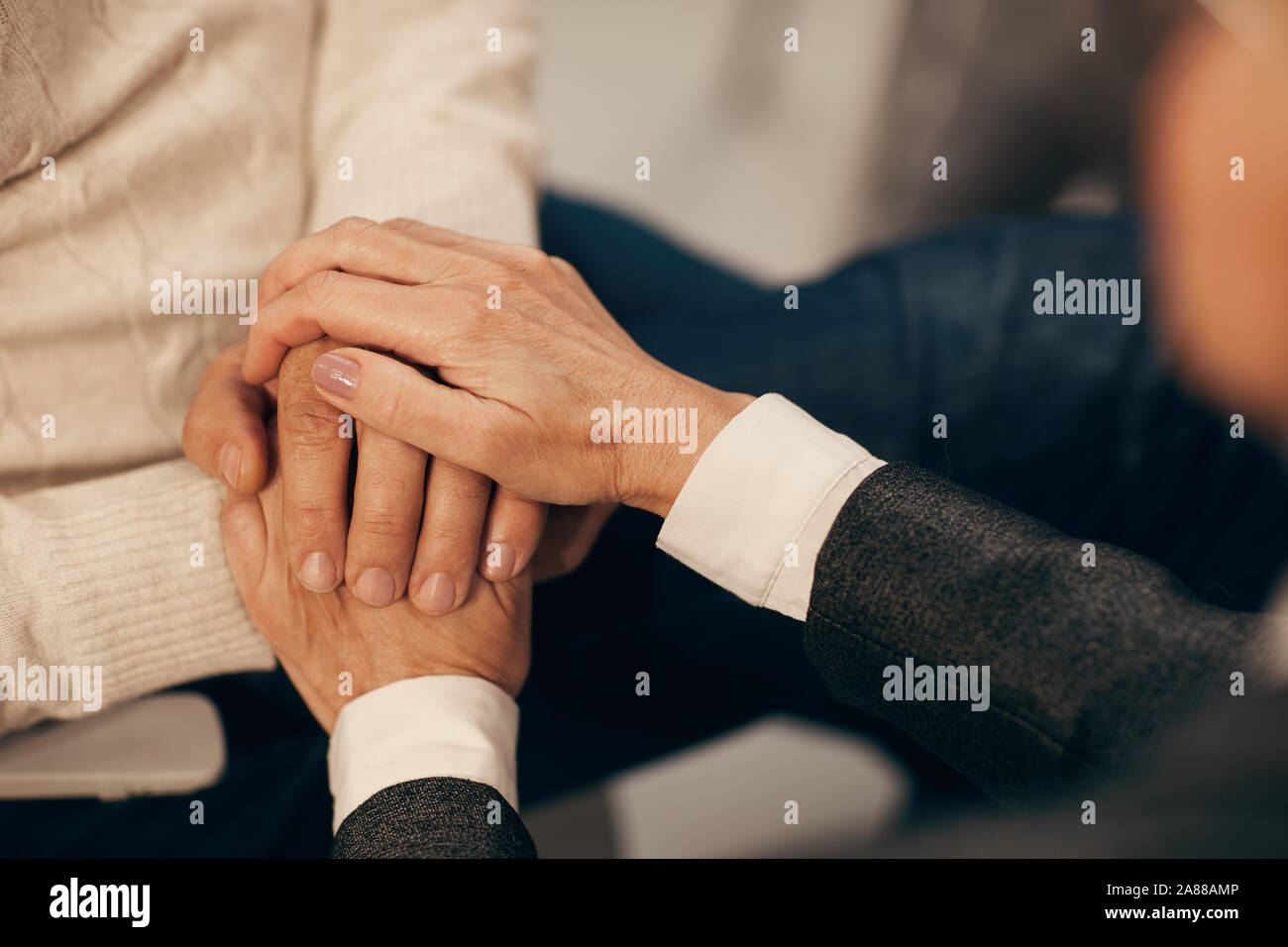 Close-up of people holding hands and support each other in difficult ...