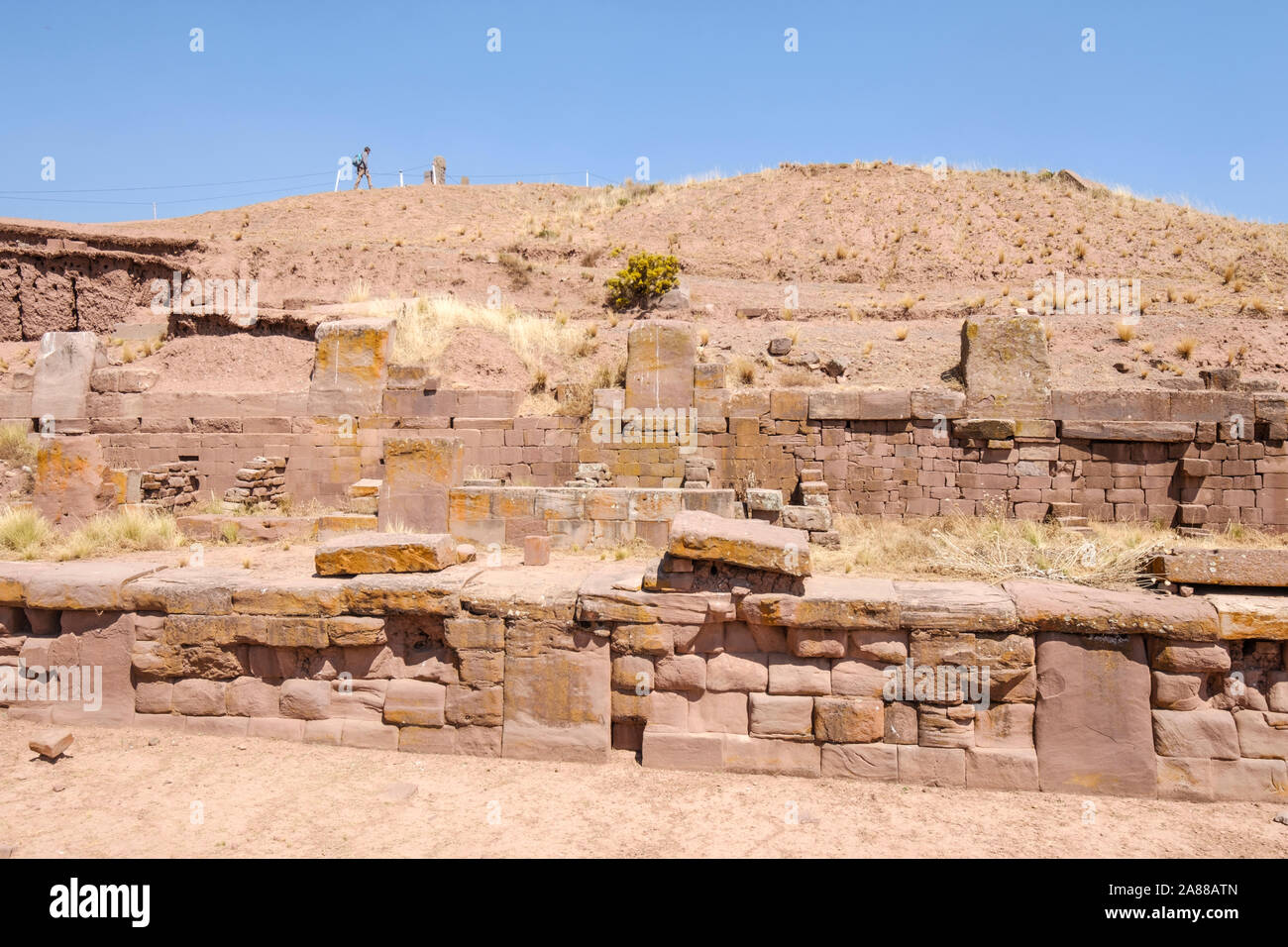 Visitor walking on the top of the Akapana pyramid at Tiwanaku ...
