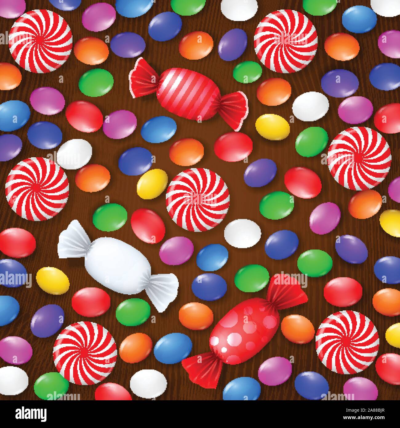 Colored candies, sweets and lollipops. On a brown wooden background ...