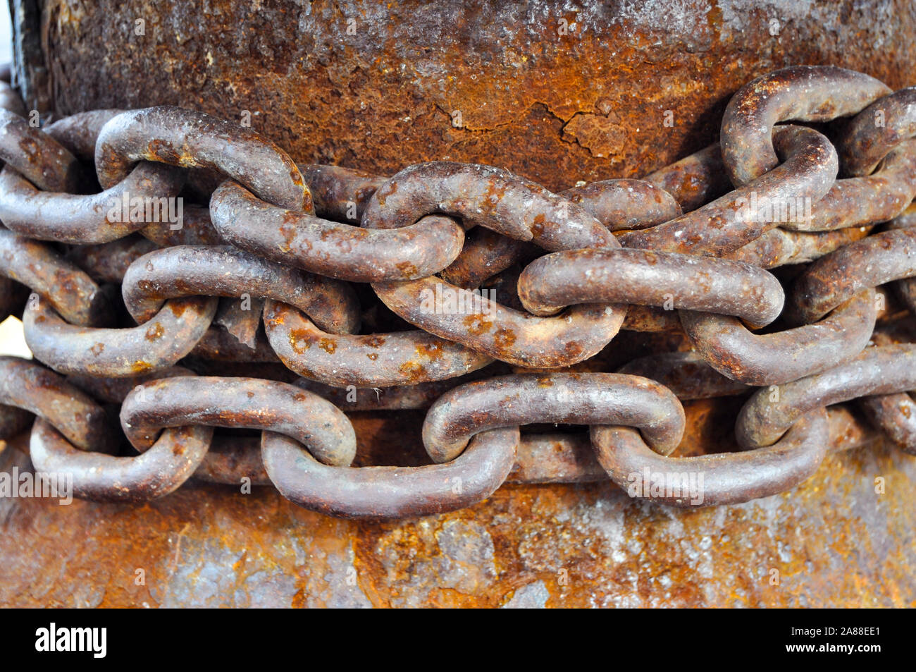 Old and rusty mooring post with rusty old chain on concrete dock of ...