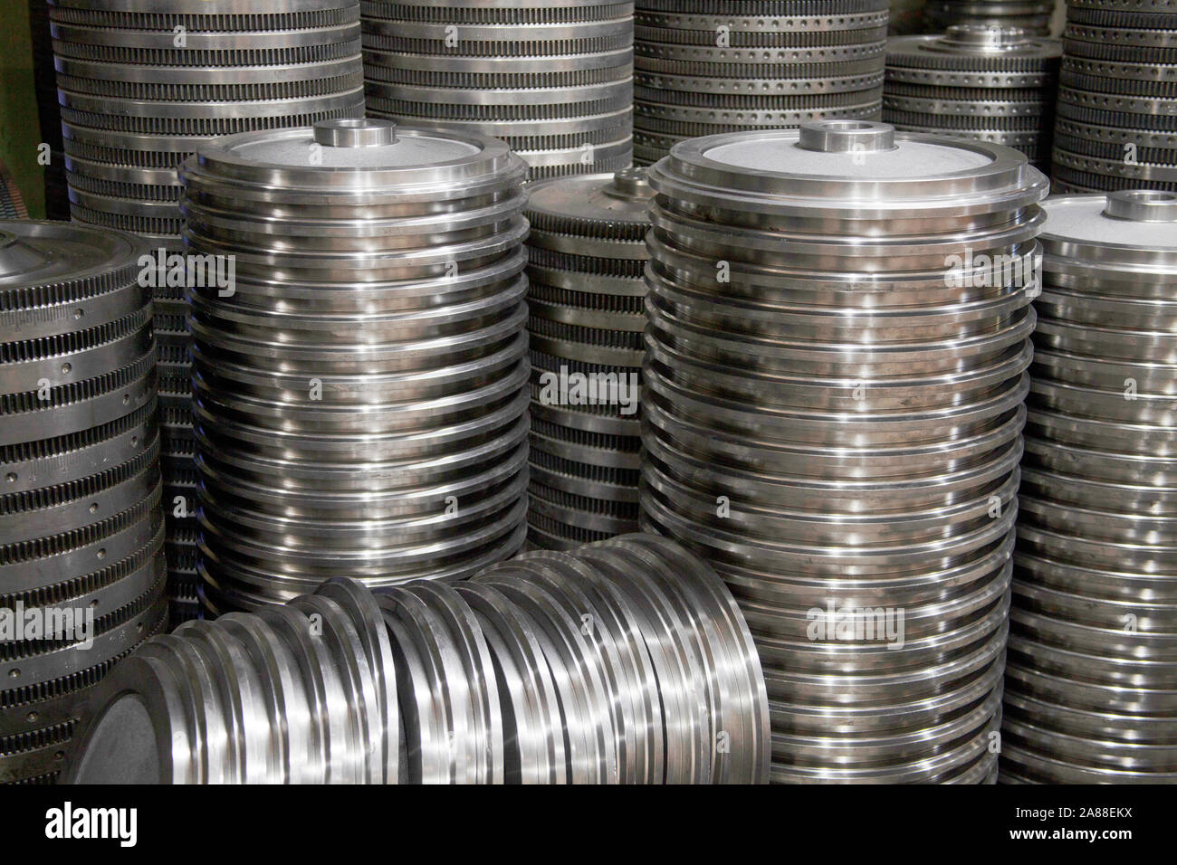 stacked steel pulleys inside factory Stock Photo - Alamy