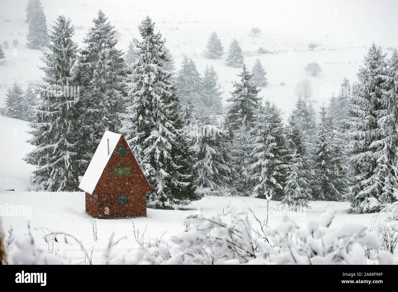 Small wooden hut in winter forest in heavy snowfall Stock Photo - Alamy