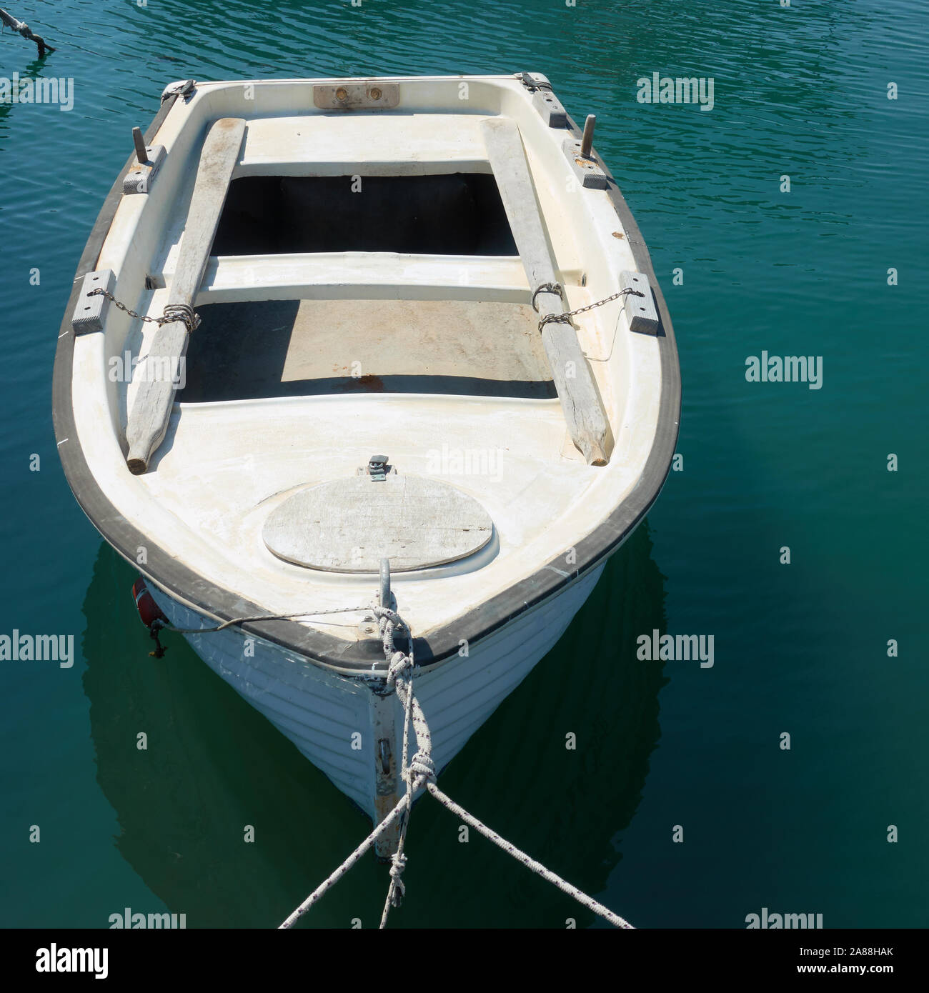 Small oar fishing boat on the water close-up Stock Photo - Alamy