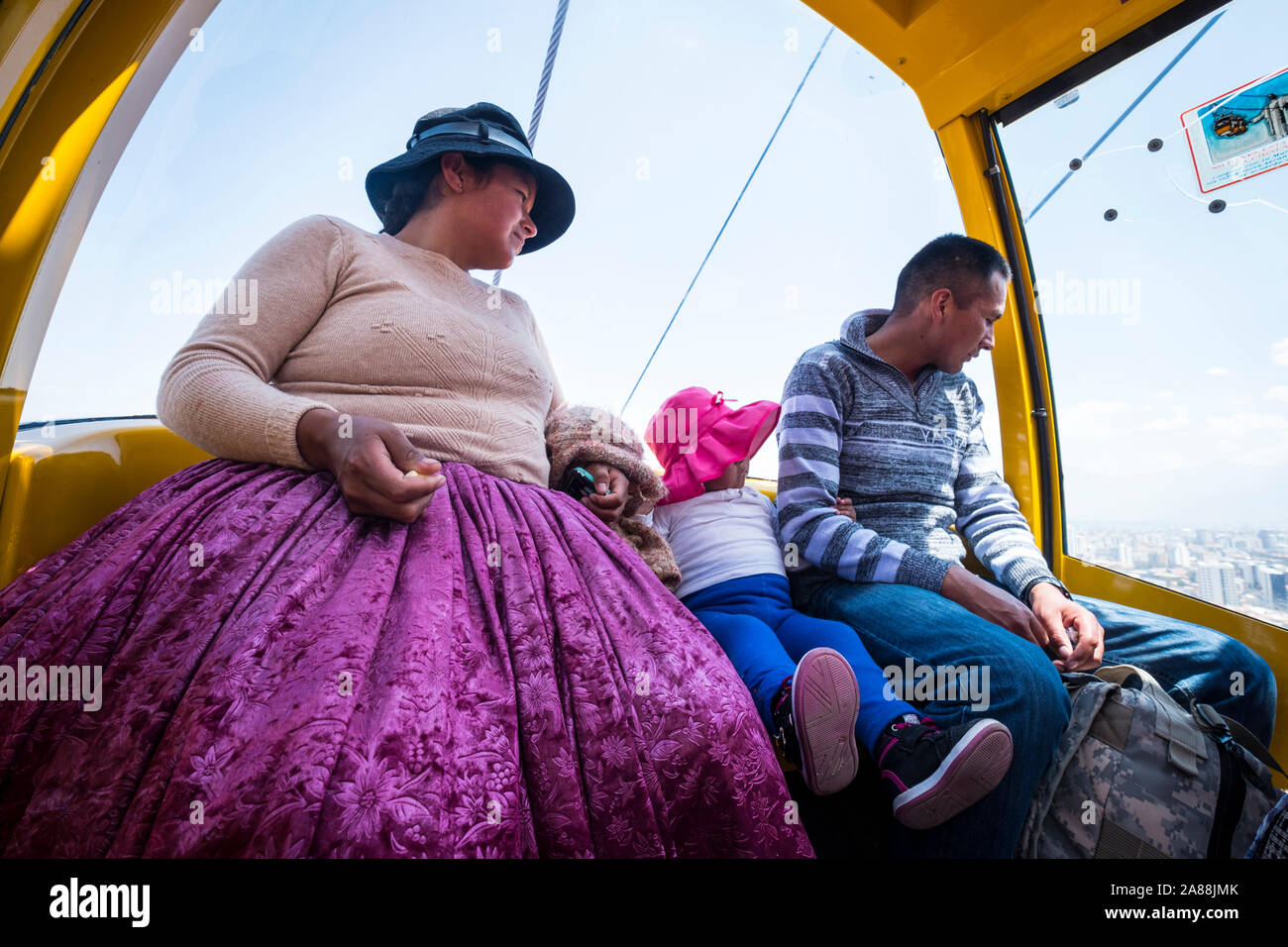 Local family inside a cabin of the popular cable car going to Cerro de ...