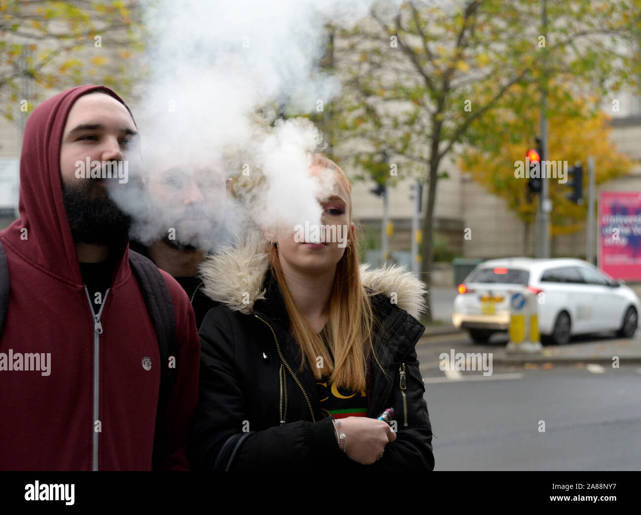 Young people vaping, exhaling Stock Photo - Alamy