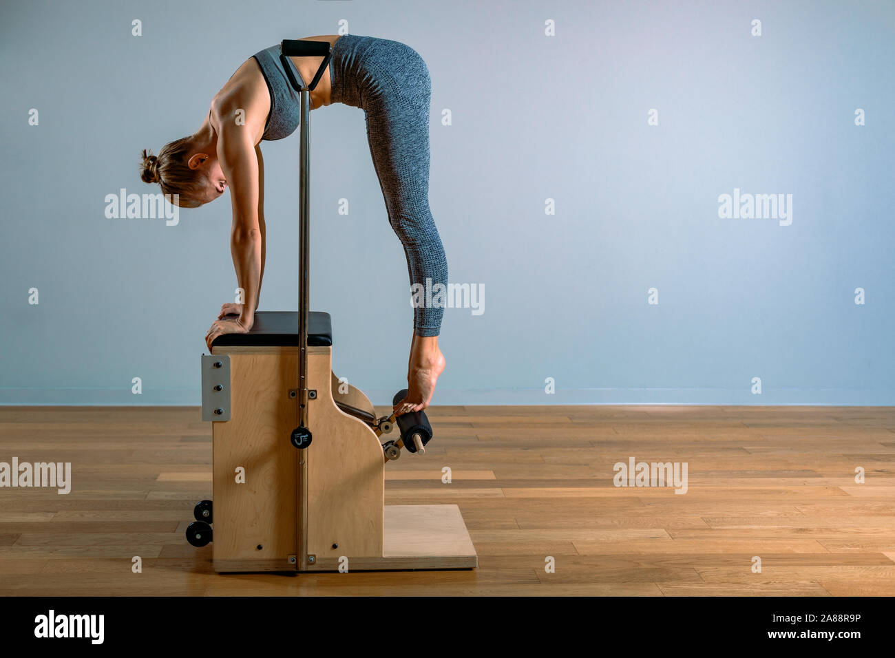 Palates trainer girl posing for a reformer in the gym. Fitness concept ...