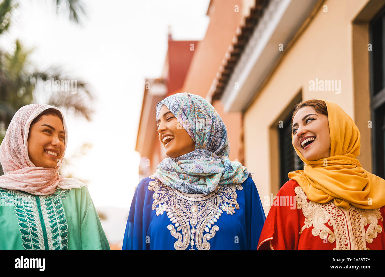 Happy Muslim women walking in the city center - Arabian young girls ...
