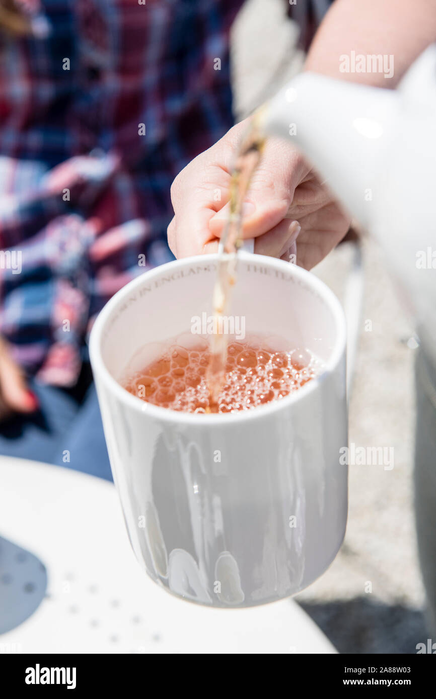Tea time Pouring English tea from a teapot cup of tea Stock Photo - Alamy