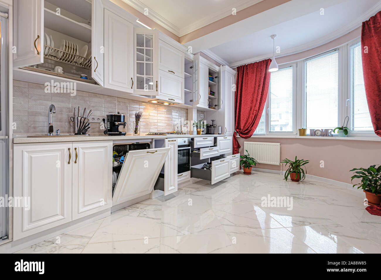 Luxury modern white kitchen interior with open doors and drawers Stock ...
