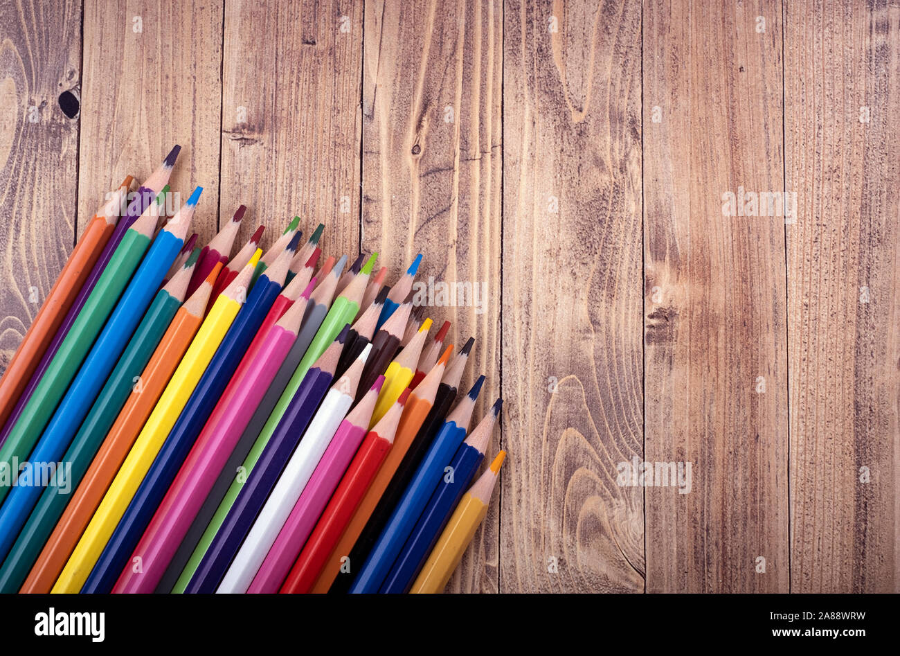 Colored wooden pencils, on a wooden base. education and school concept ...