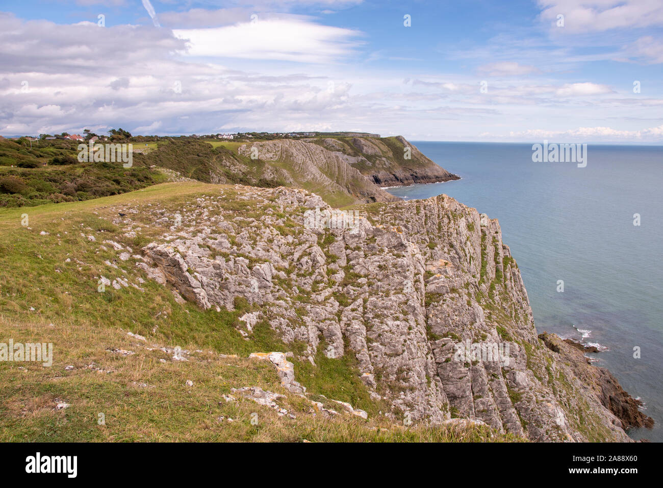 Rocky cliffs line the dramatic coast of Wales on the Gower Peninsula ...