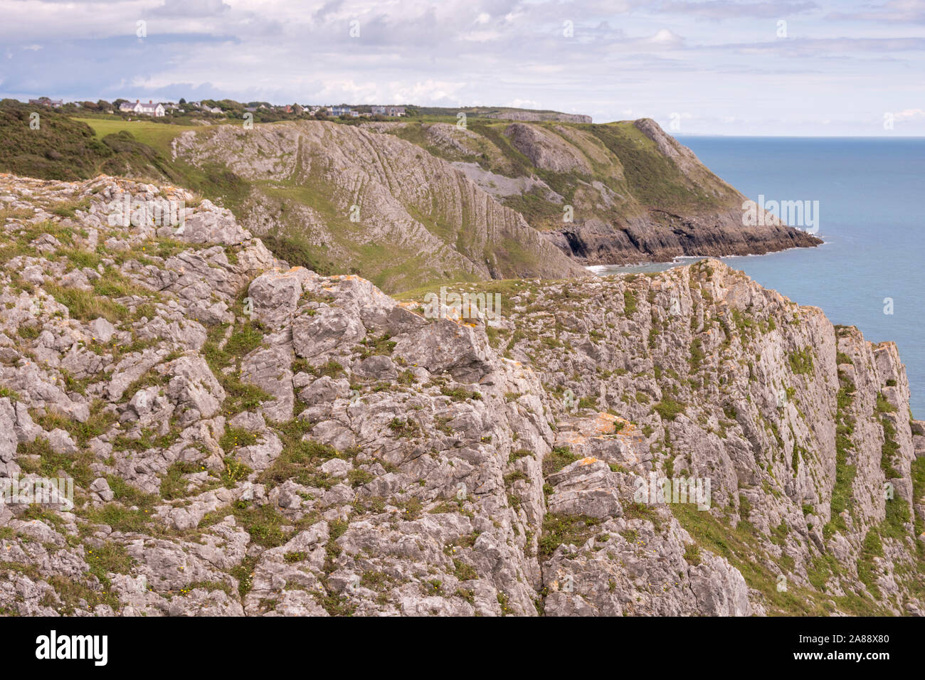 Rocky cliffs line the dramatic coast of Wales on the Gower Peninsula ...