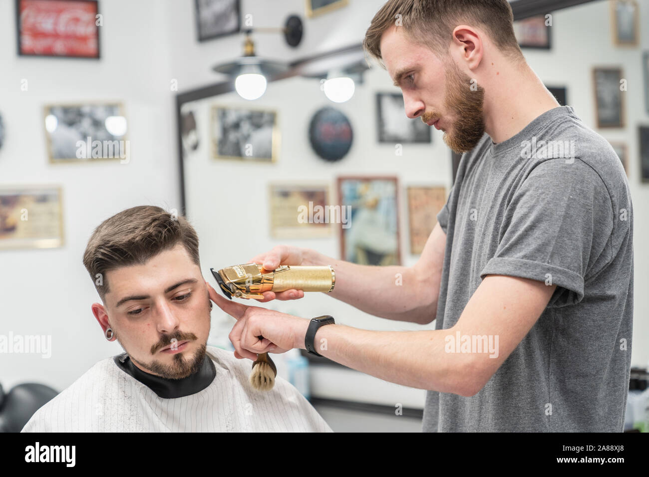 Barber making hairstyle confident hi-res stock photography and images ...