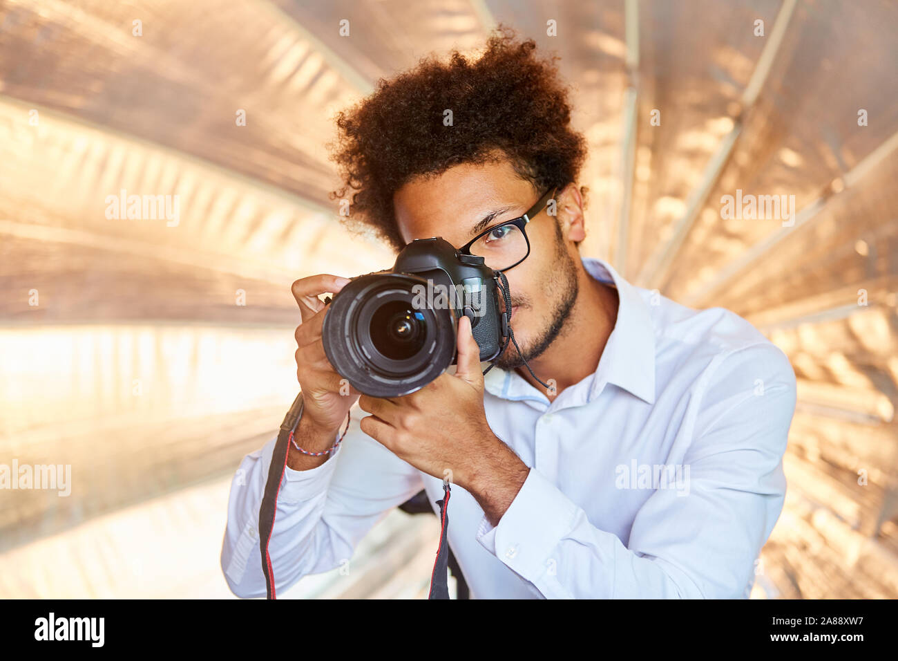 Creative young photographer or photo student while photographing in ...