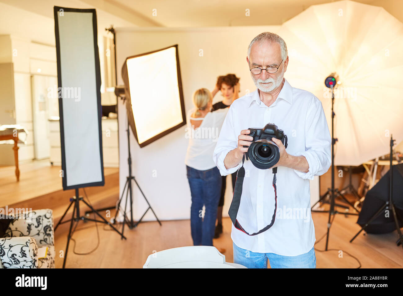 Experienced photographer controls his digital camera before the photo ...