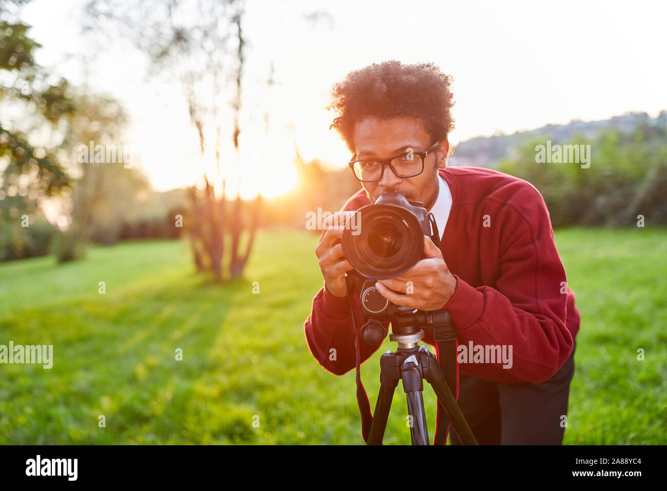 Young hobby photographer as nature photographer with camera on the ...