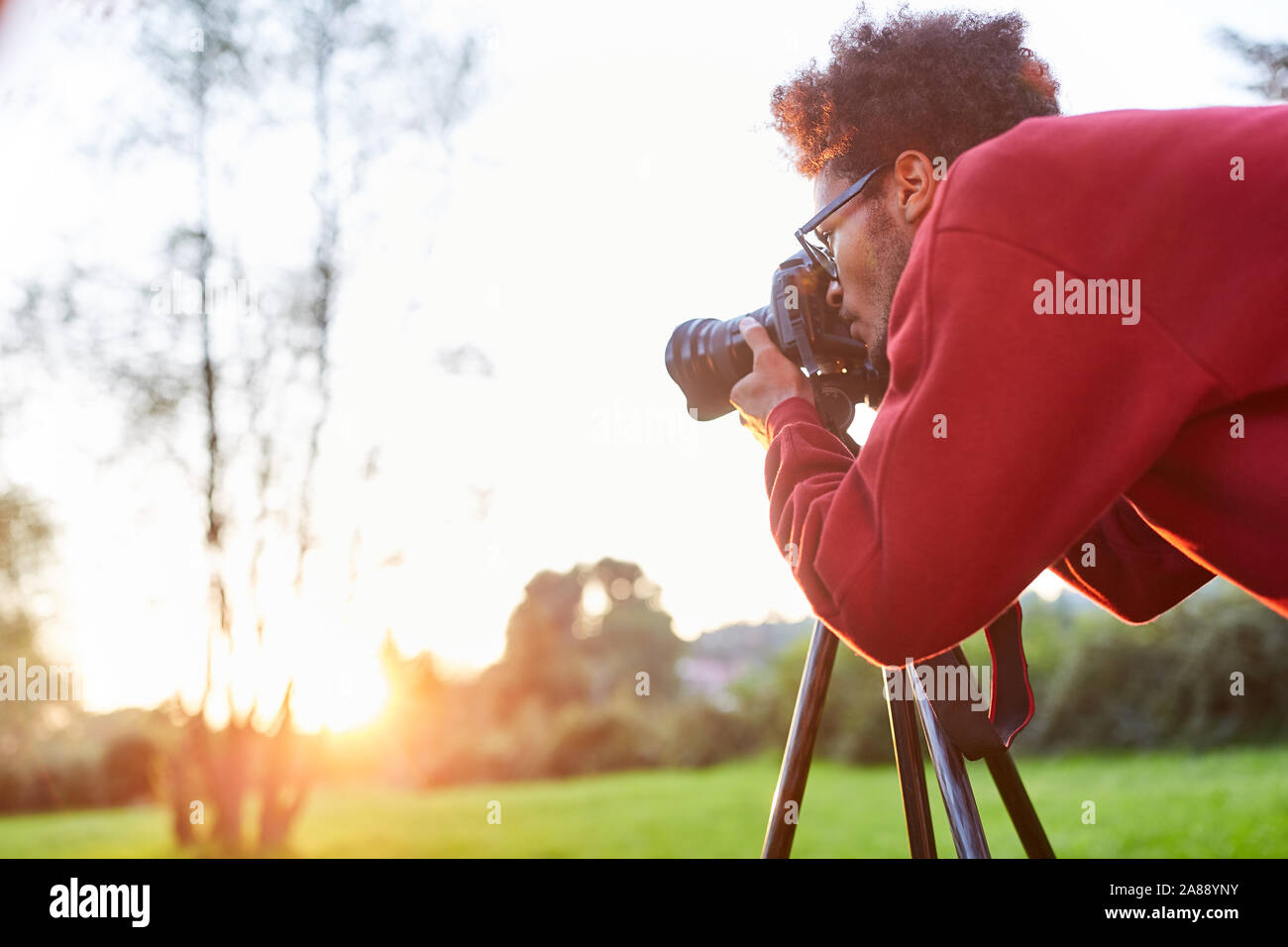 Photographer as landscape photographer with camera on tripod while ...