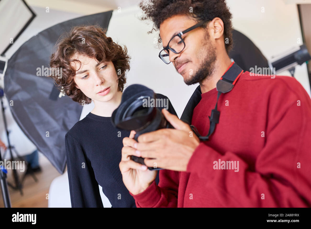 Photographer and photo assistant with camera in preparation of ...