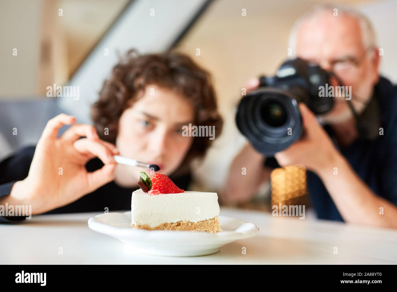 Photo assistant and photographer styling and photographing food Stock ...