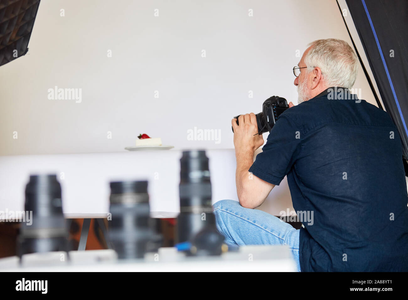 Professional food photographer with camera photographs food Stock Photo ...