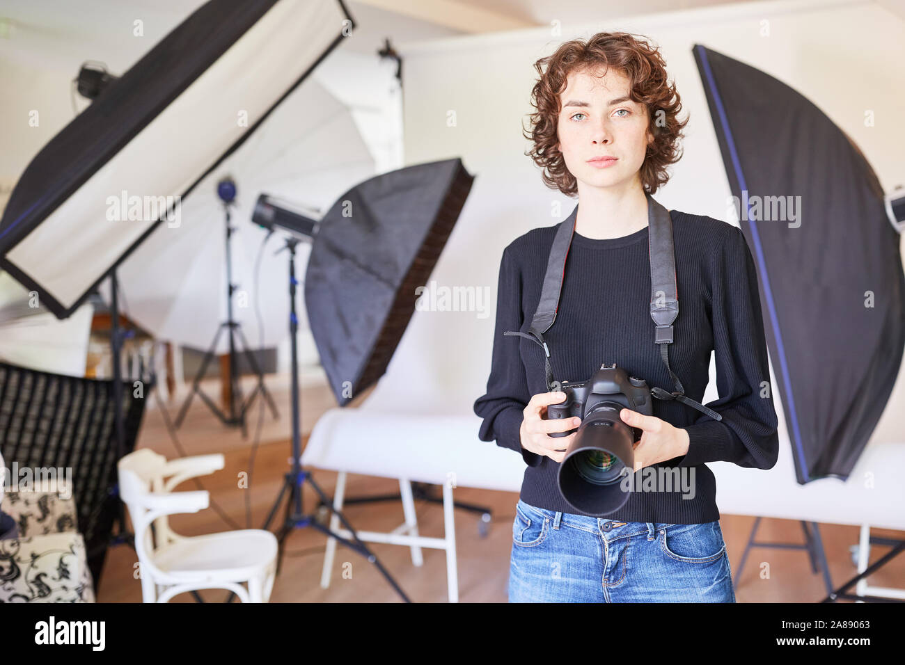 Professional photographer with SLR camera in the photo studio Stock ...