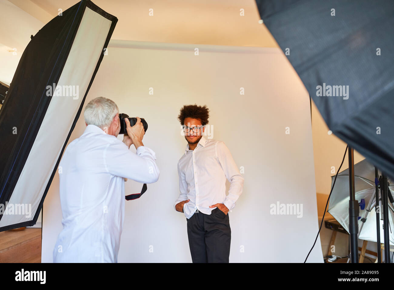 Photographer photographs man as a model for portrait photos at the ...