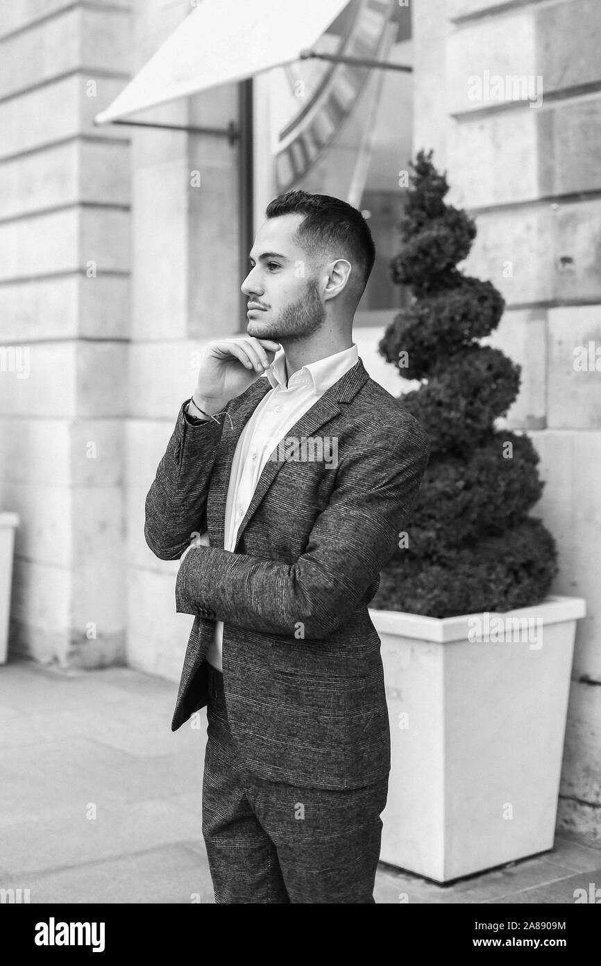 Black and white bw portrait in Paris. Young cacuasian man wearing suit ...